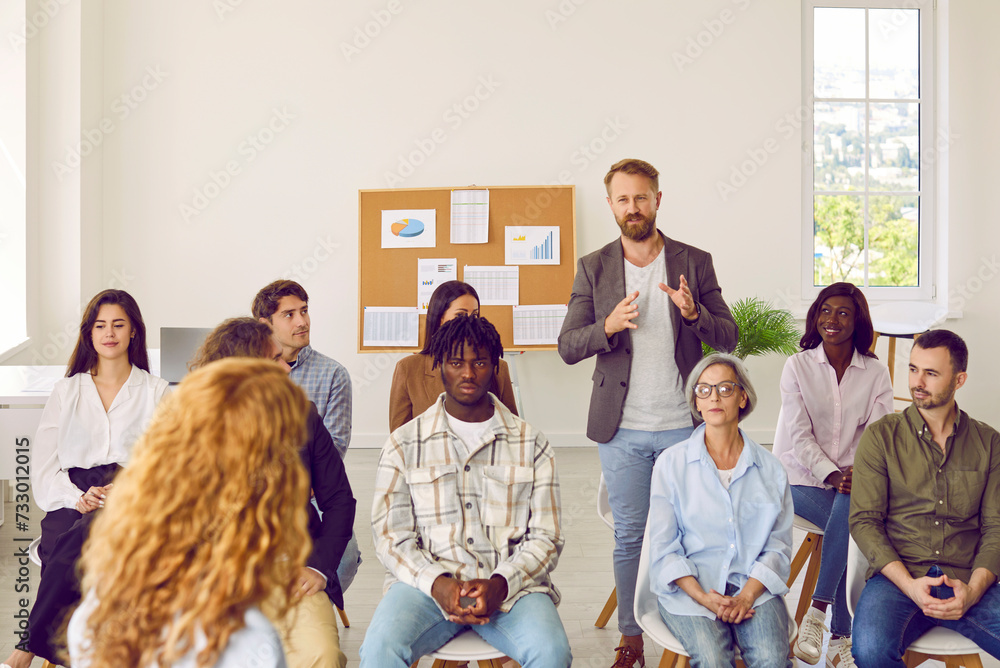 Male business speaker and professional financial coach giving training ...