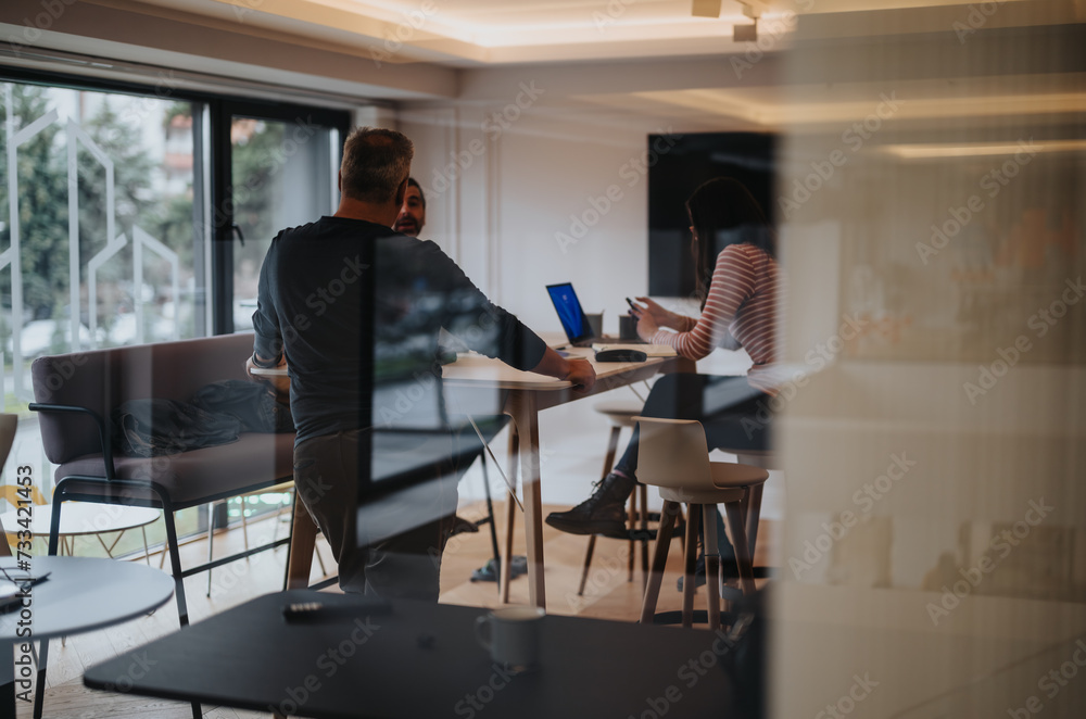 A professional and relaxed setting captures a business meeting between ...