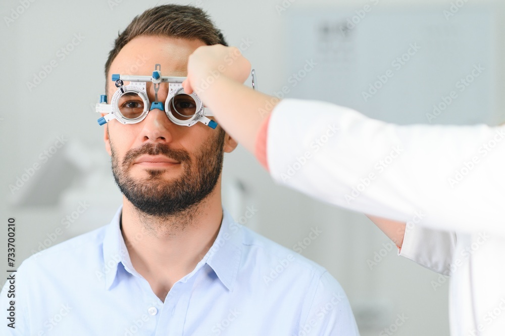 Ophthalmology concept. Male patient under eye vision examination in ...