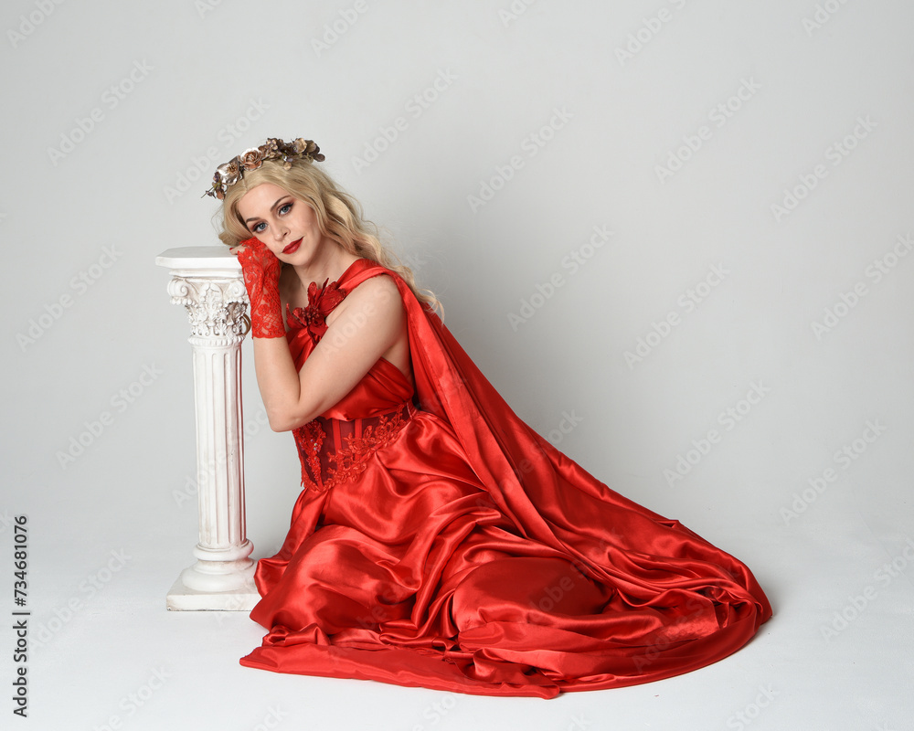 Full length portrait of beautiful blonde model dressed as ancient ...