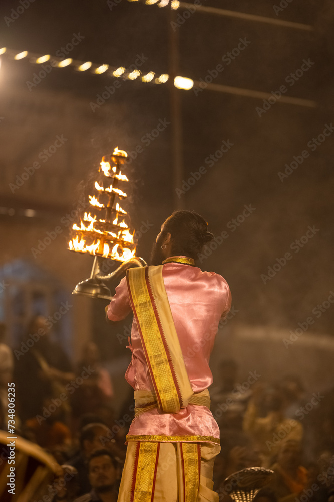 Ganga aarti, Portrait of young priest performing holy river ganges ...