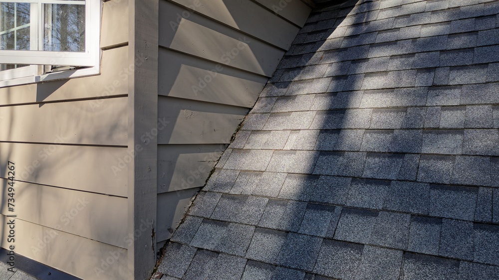 Drone view of damaged rotten wood siding along shingles due to improper ...