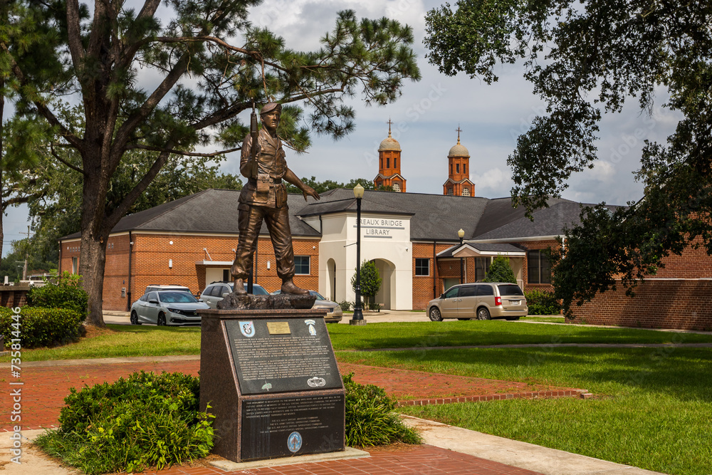 Statue near public library building, installed in honor of the Green ...