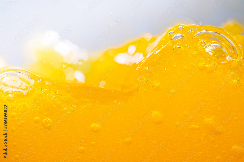 Close up bright orange juice splash texture for health and nature waves ...