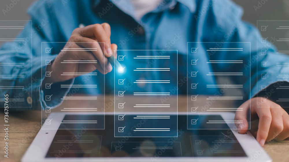Checklist concept. Businessman using tablet. Checking marks on ...