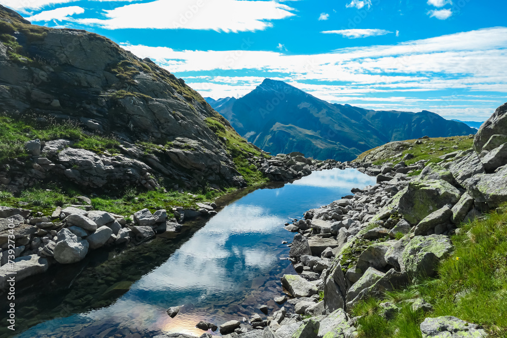 Photo Stock Small high altitude alpine lake surrounded by rocks in High ...