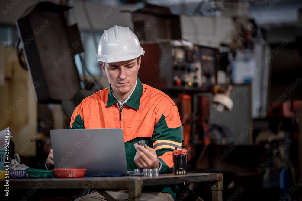 Industry engineer wearing safety uniform control operating lathe ...
