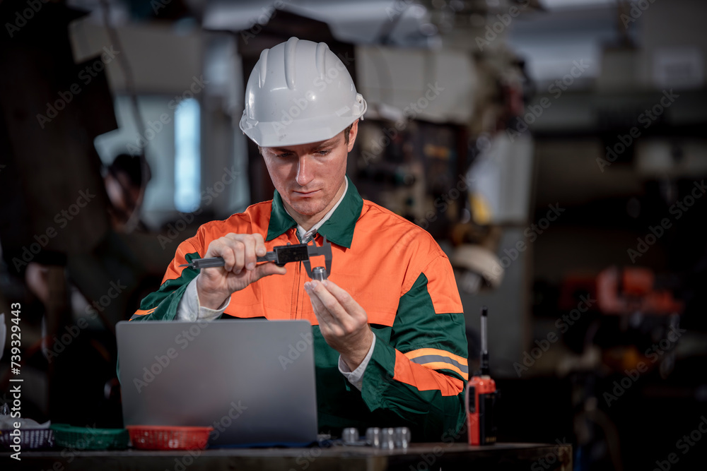 Photo Stock Industry engineer wearing safety uniform used vernier ...