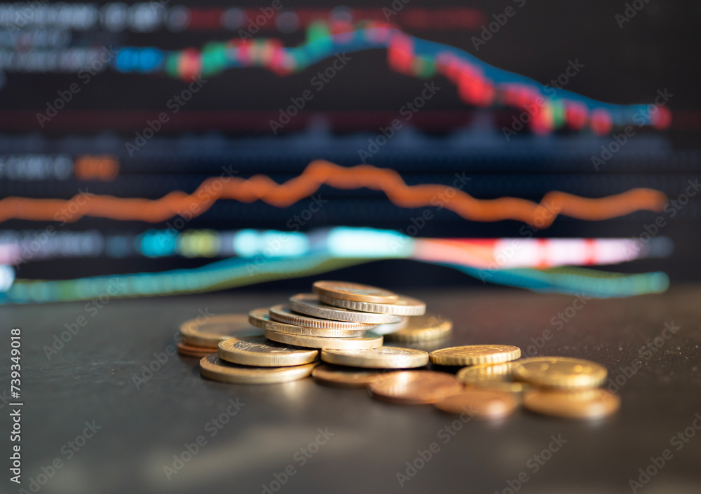 Coins currency from several different countries with stock graph ...