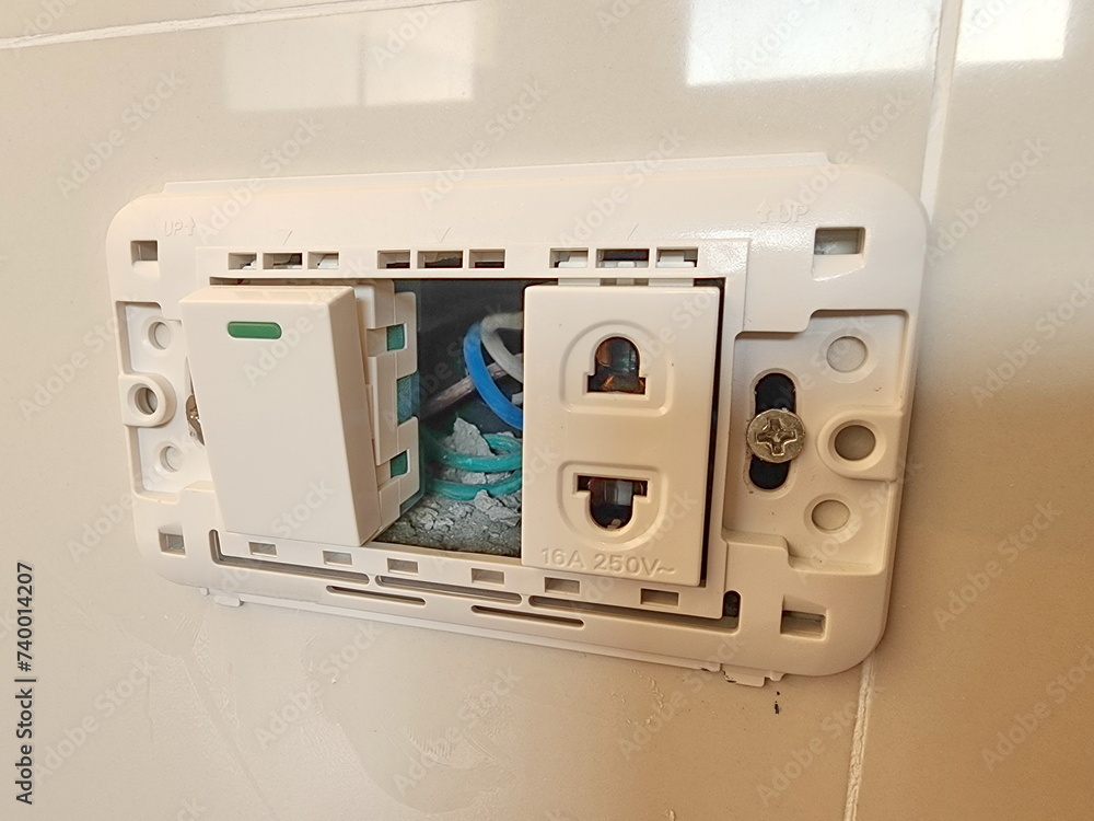 Installing light switch. On-off switch and mounted socket board with ...