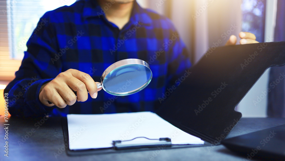 Audit assessment concept with auditor use magnifying glass look into ...