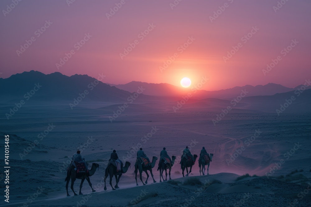 A caravan of camels walking in line on a desert dune under a vibrant ...