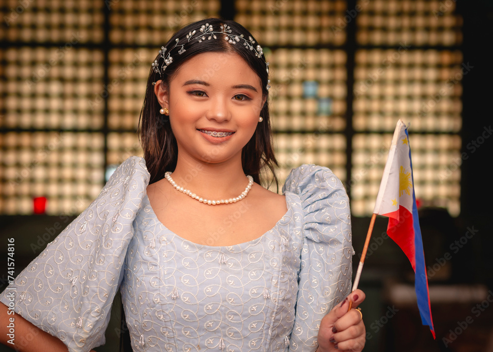 A beautiful radiant young Filipino woman in a grayish blue baro’t saya ...