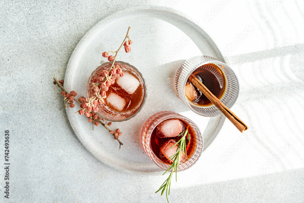 Overhead view of Three different cocktails on a stone tray with berry ...