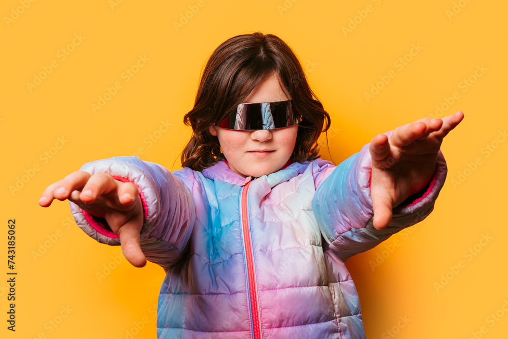Confident girl posing with futuristic glasses and extending her hands ...