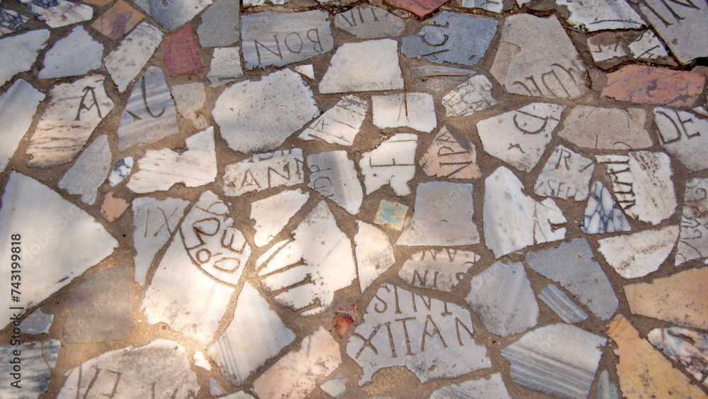 Ancient Roman stones with inscriptions used to make a paved floor in ...