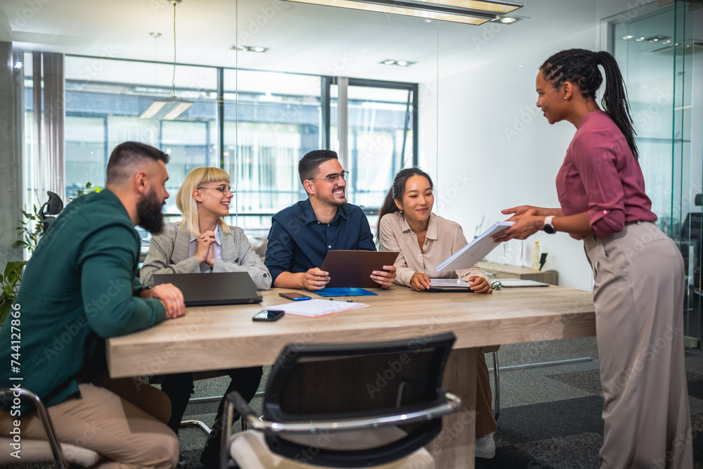 Office colleagues having discussion during meeting in conference room ...