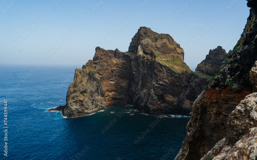 Red rock pillar protruding out of the Atlantic Ocean at the Ponta de ...