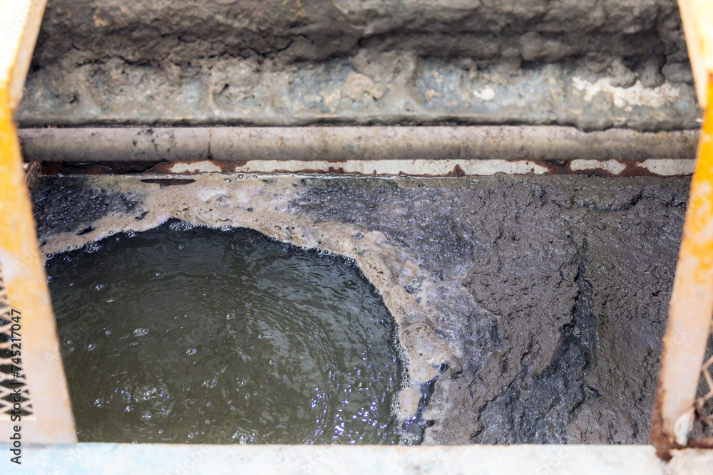 Dirty bubbles floating on waste-water surface water from factory or ...