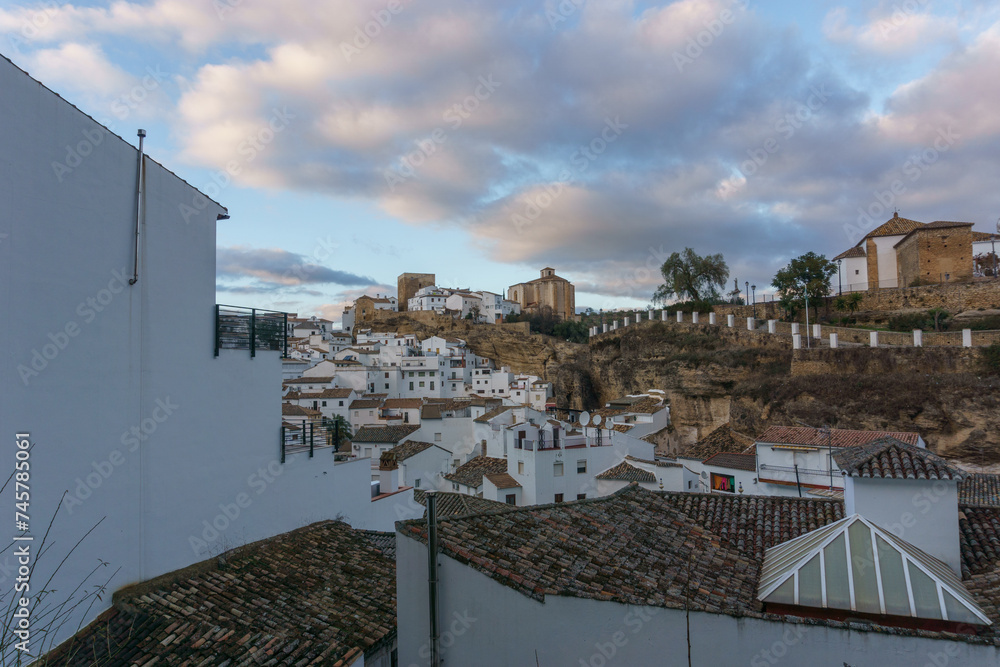 View over typical andalusian village with white houses and street with ...