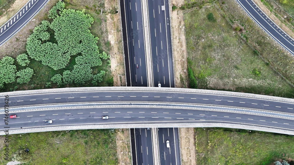 An overhead perspective of a highway featuring two lanes for vehicles ...