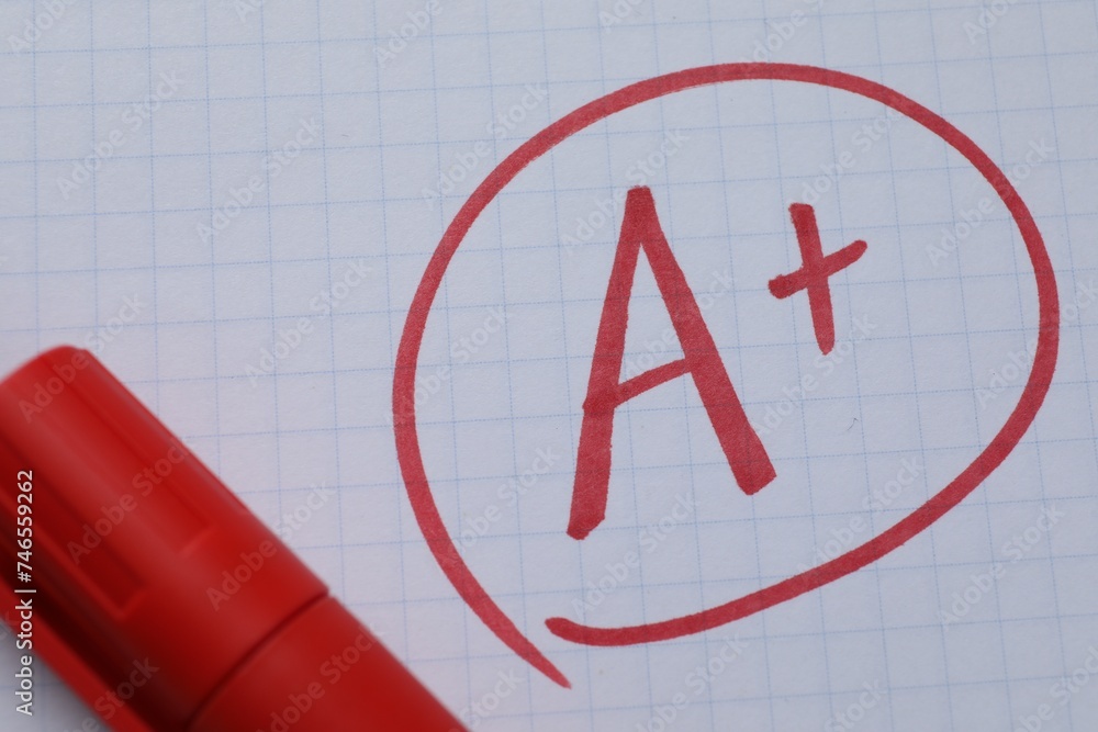 School grade. Red letter A with plus symbol on notebook paper and ...