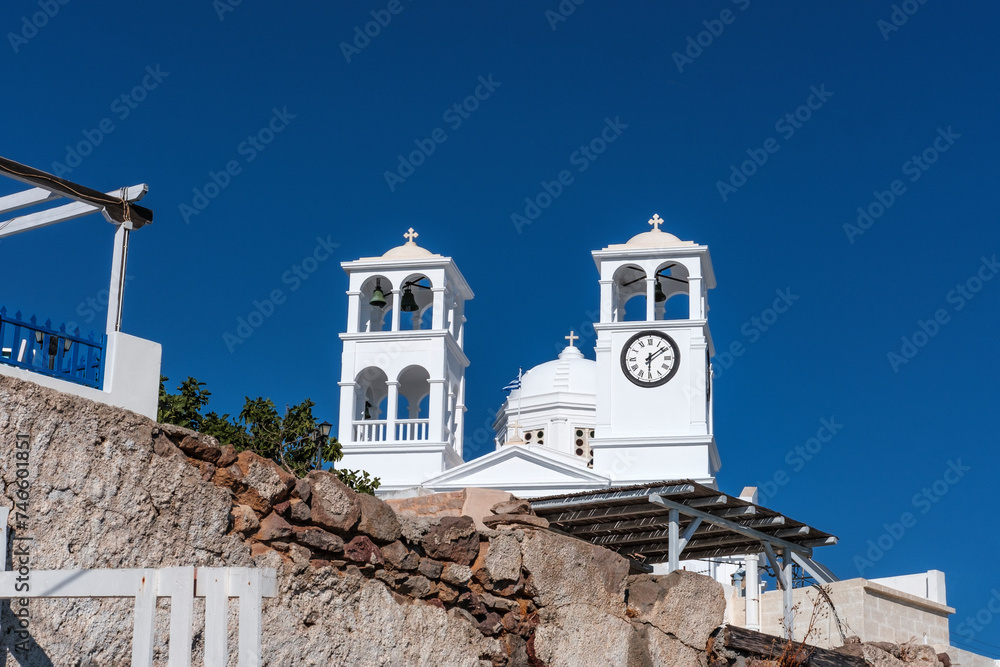 bell and clock tower of typical Greek Orthodox church, whitewashed ...