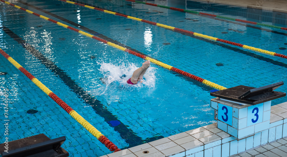Sportswoman, a professional swimmer at the start of the swimming race ...