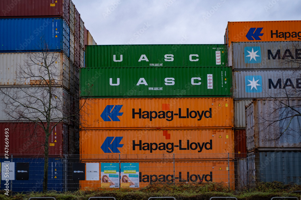 Shipping containers largest shipping and transportation companies stacked in port, Hapag-lloyd ...