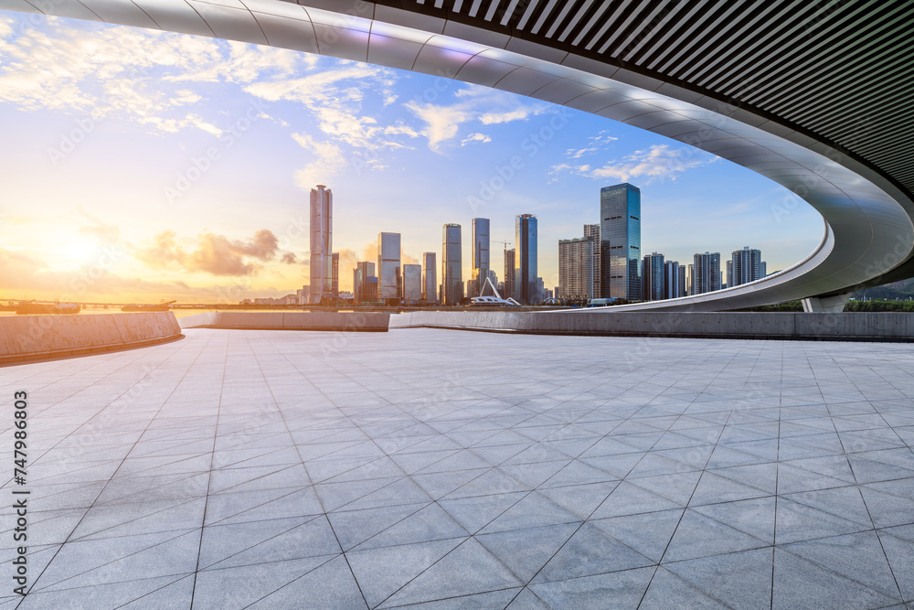 Empty square floor and pedestrian bridge with modern city buildings ...