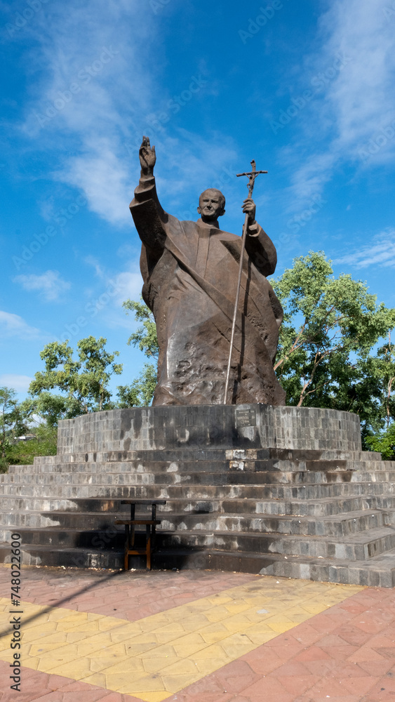 Religious statue of Pope John Paul II in the capital city of Dili ...