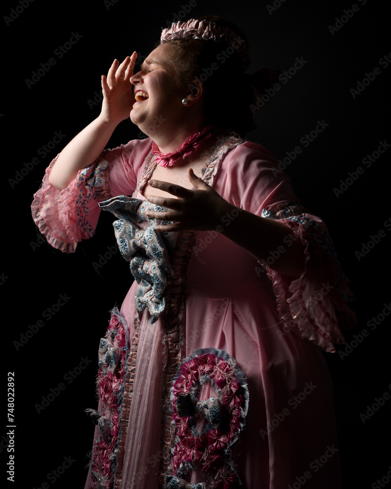 close upProfile portrait of female model wearing an opulent pink gown ...