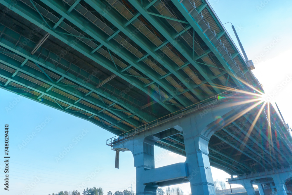 Parts of a modern metal bridge in close-up against a blue sky ...