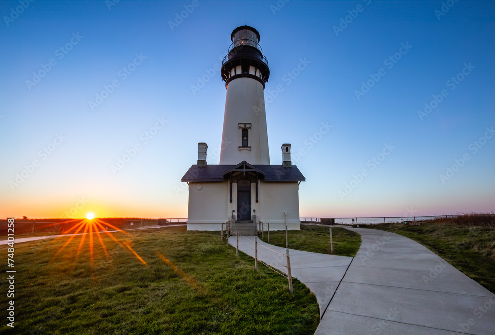 The Yaquina Head Lighthouse at Newport Oregon stands as a landmark. A ...