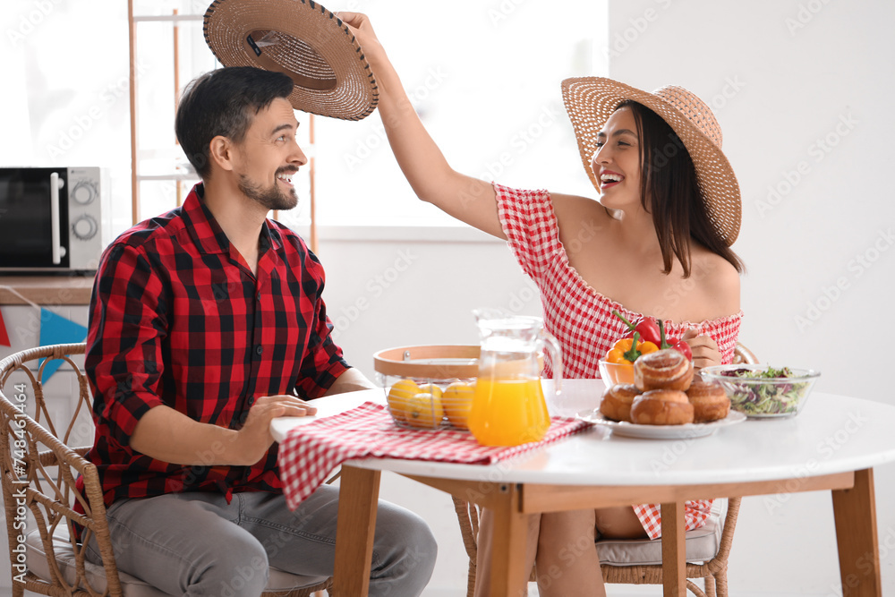 Young couple celebrating Festa Junina (June Festival) in kitchen Stock ...
