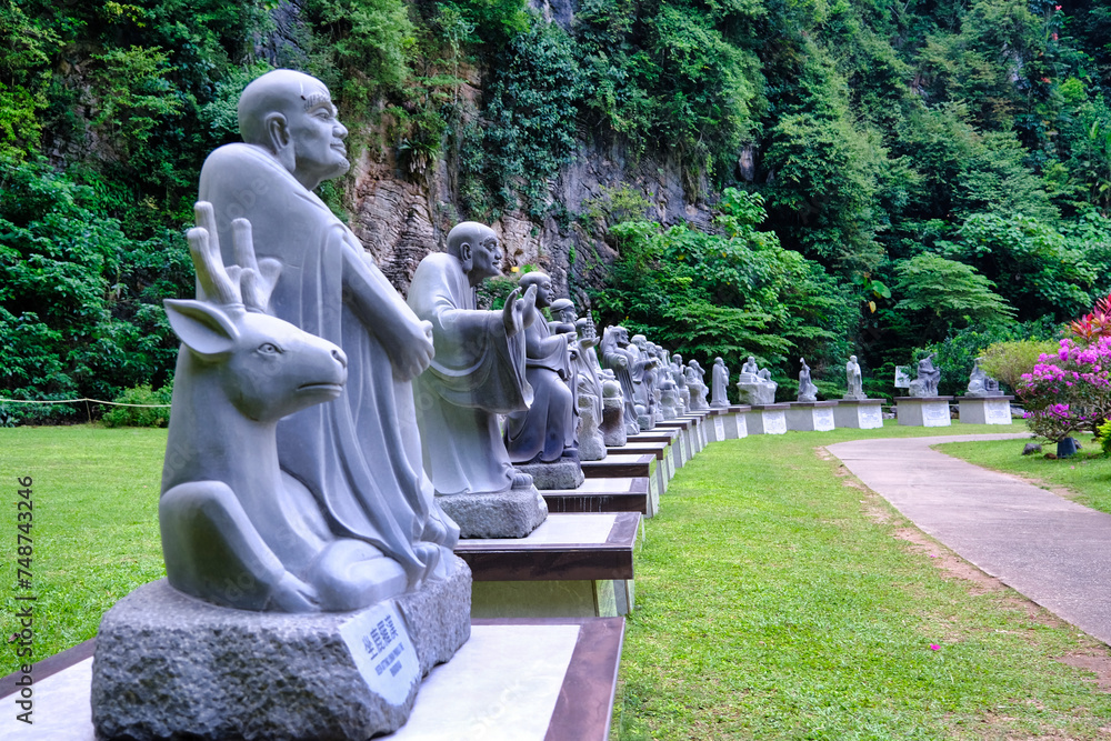 Numerous statues grace the exterior of the temple in Ipoh, Malaysia ...