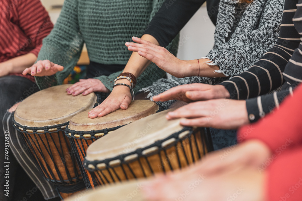 Group of people playing drums during a music therapy lessons, jembe ...