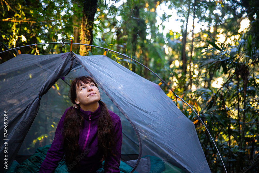 pretty girl sitting in a transparent tent and admiring unique ...