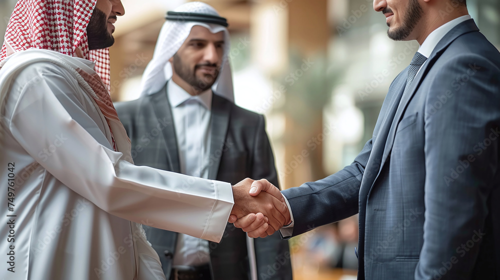 Business handshake between two men in traditional and modern attire ...