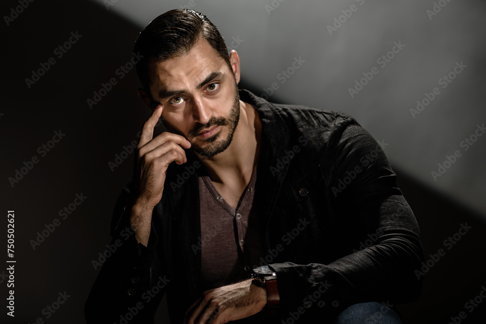 Handsome brutal macho guy posing on dark gray background, Young man's ...