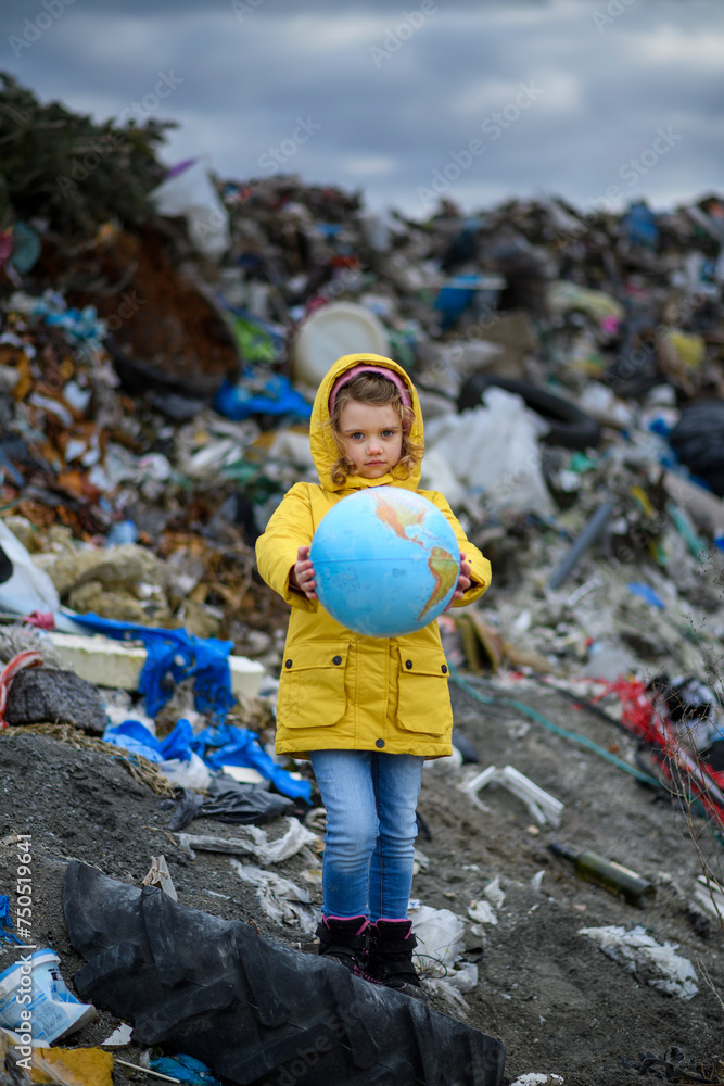Young girl holding planet Earth model, globe, standing standing on ...