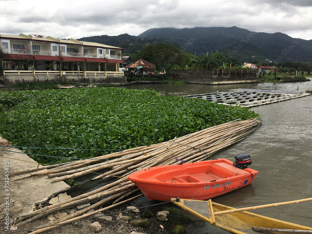 fishing boat made of beef tendon plastic was anchored next to a cluster ...