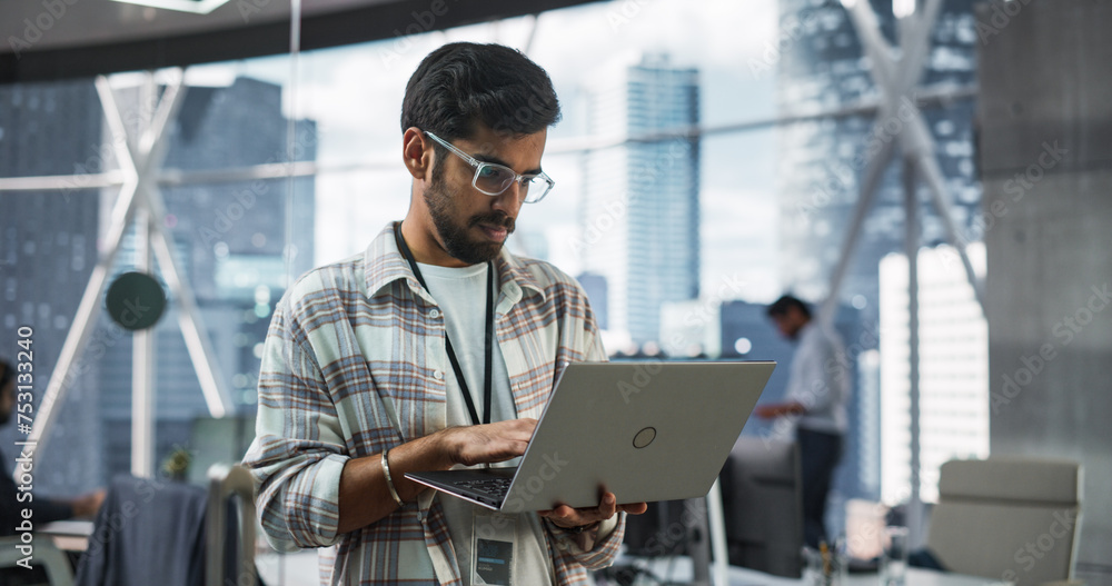 Indian Male Business Analyst Standing with Laptop Computer in a Modern ...