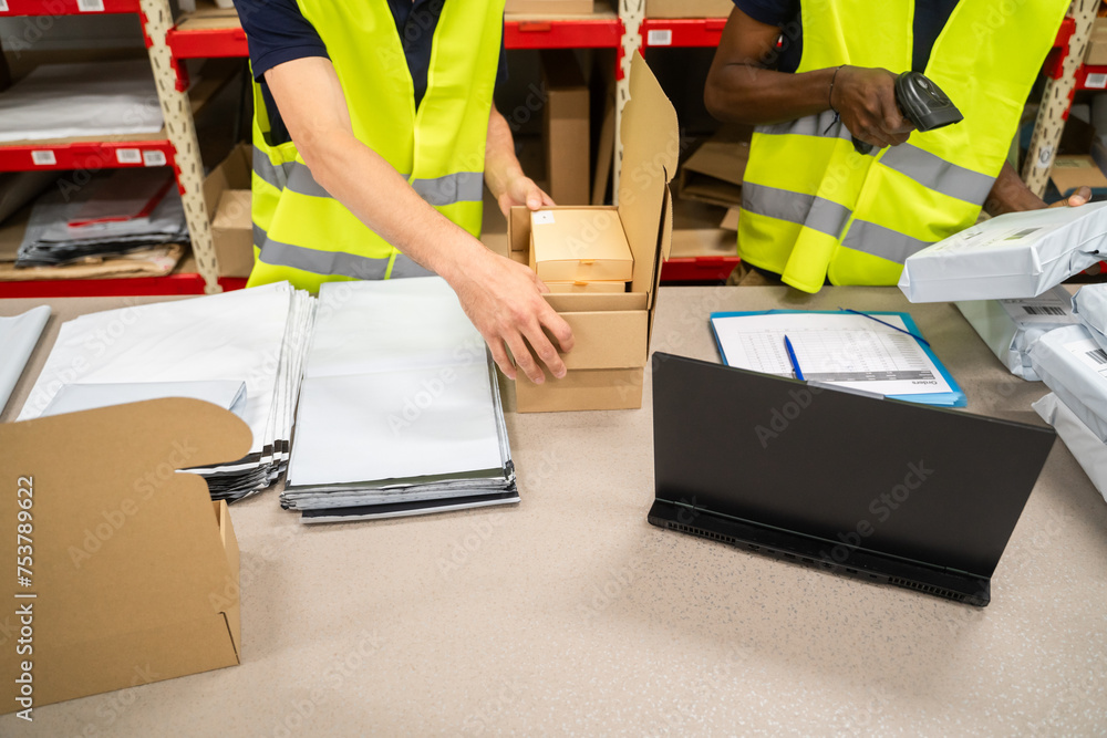 Anonymous Workers Packing And Scanning Parcels At The Desk Stock Photo ...