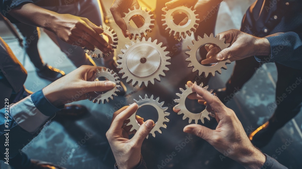Stock-Foto „Office workers holding cog wheel as unity and teamwork in ...