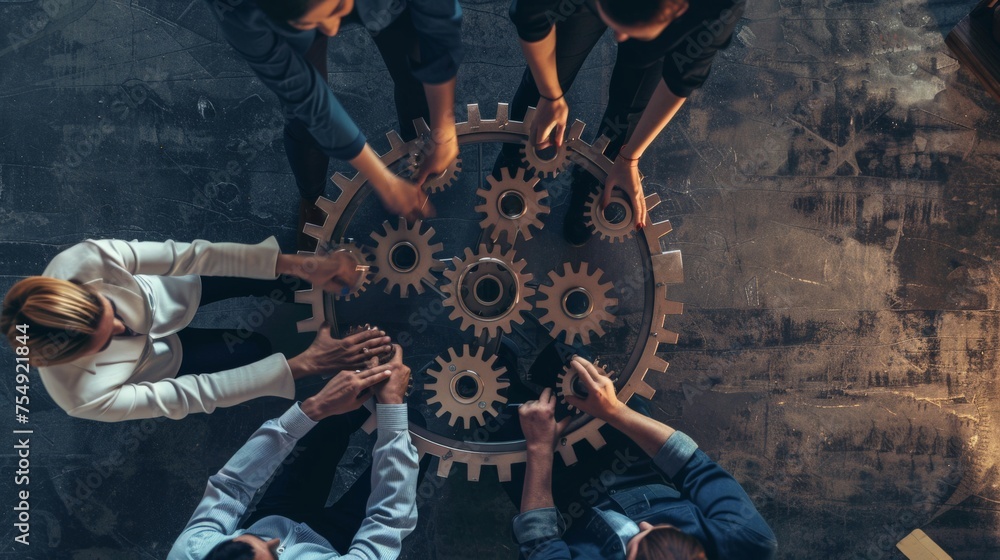 Office workers holding cog wheel as unity and teamwork in corporate ...