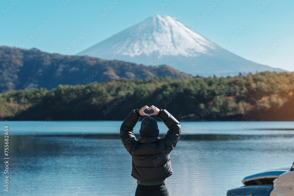 Woman tourist enjoy with Fuji Mountain at Lake Saiko, happy Traveler ...