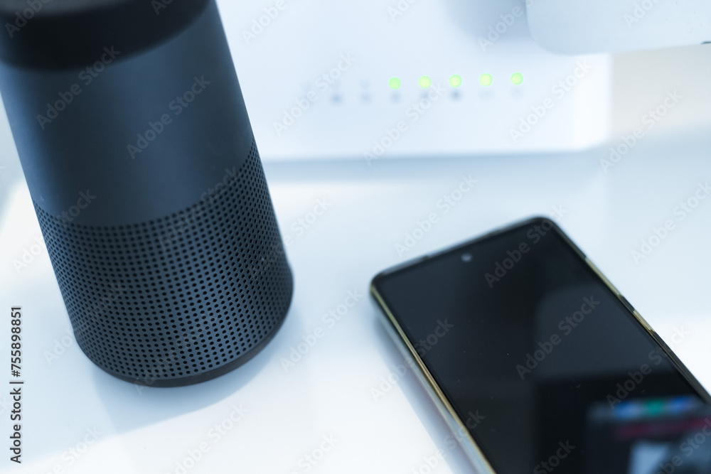 Smartphone, wifi speaker, router and computer on desk. Technology ...
