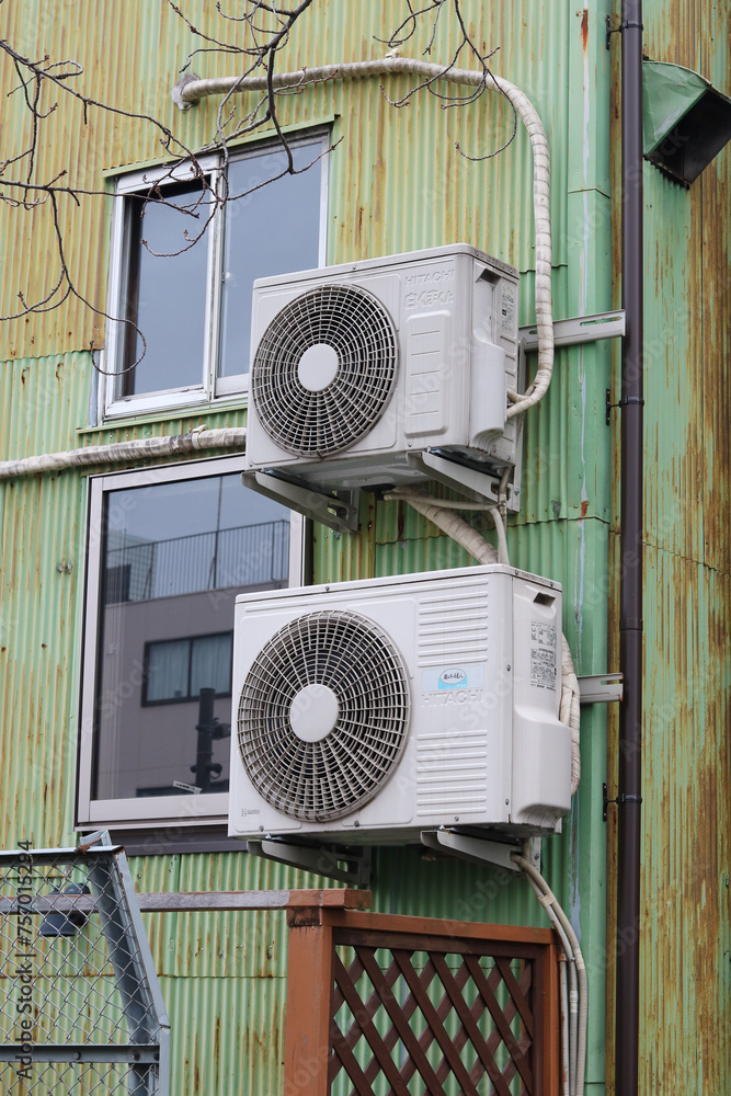 TOKYO, JAPAN - January 3, 2024: Air conditioner condenser units on the ...