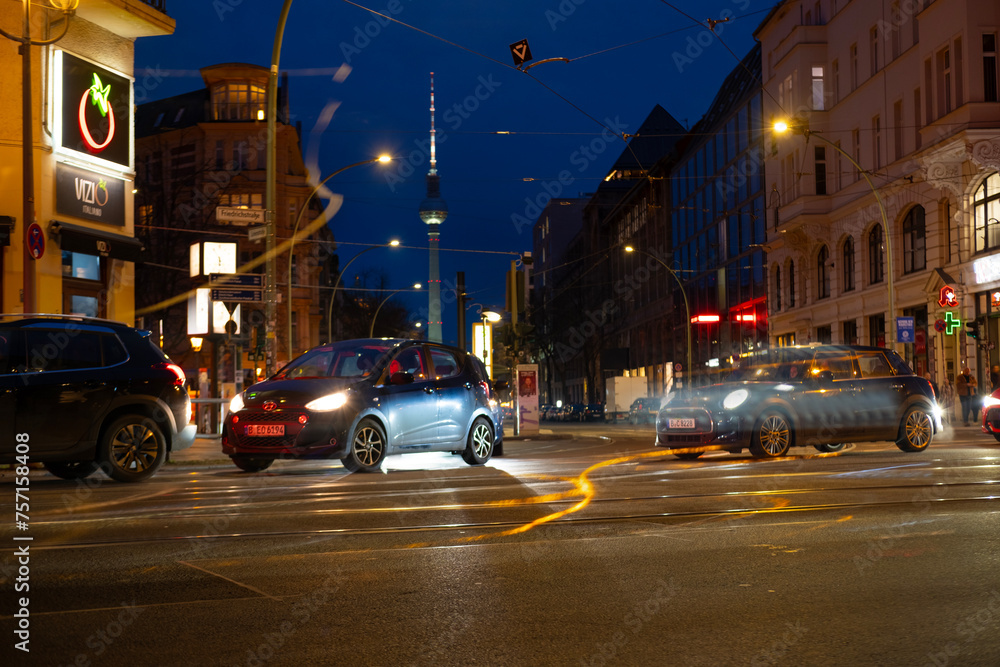 Cars driving down night Oranienburger street, Illuminated buildings and ...